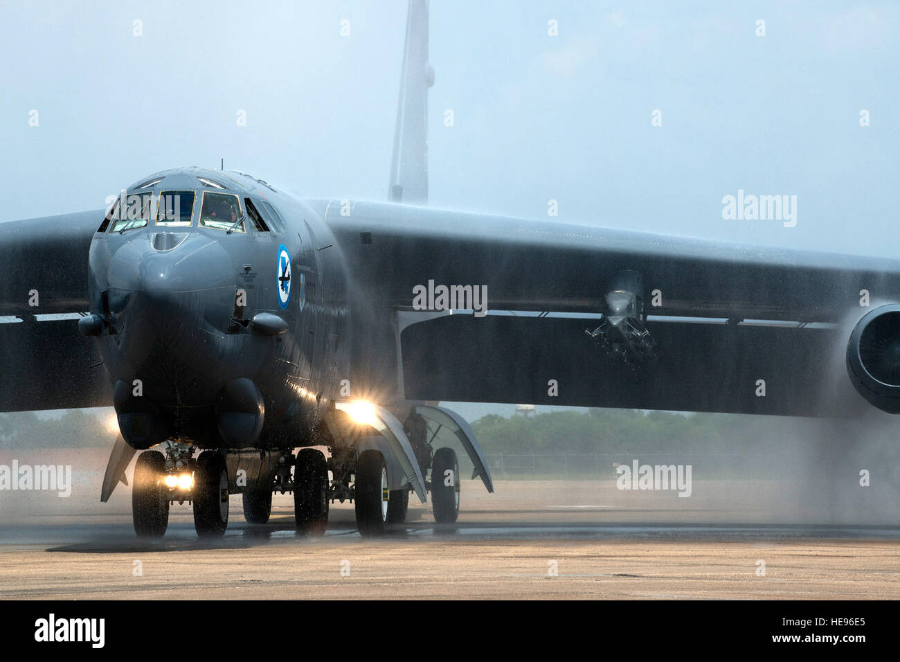 A 2nd Bomb Wing B-52H Stratofortress taxis under a spray of water after ...