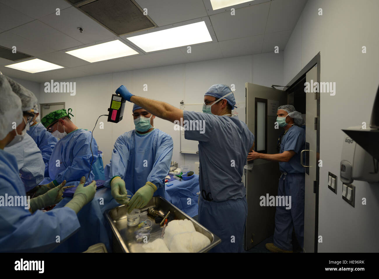 U.S. Air Force Master Sgt. Glenn Dosado (center), a scrub technician ...