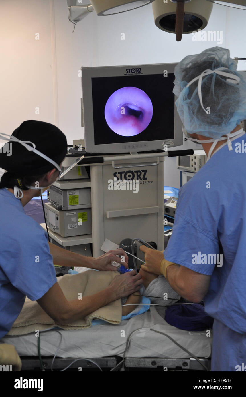 Craig Joint Theater Hospital medical team members use a bronchoscope to ...