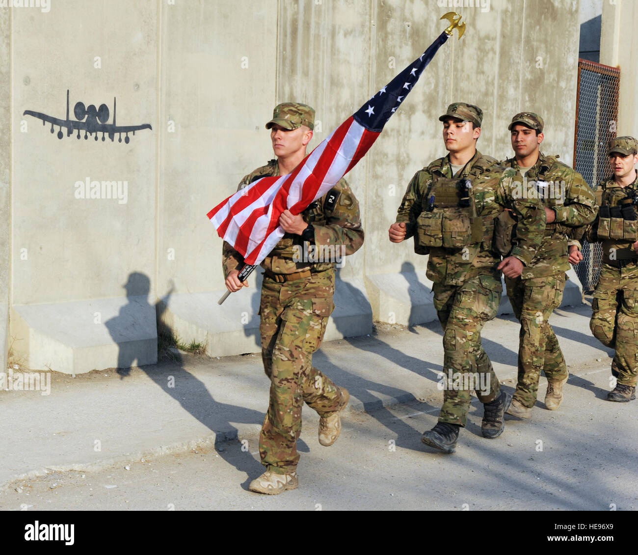 A multiservice formation of special operators runs with a U.S. flag ...