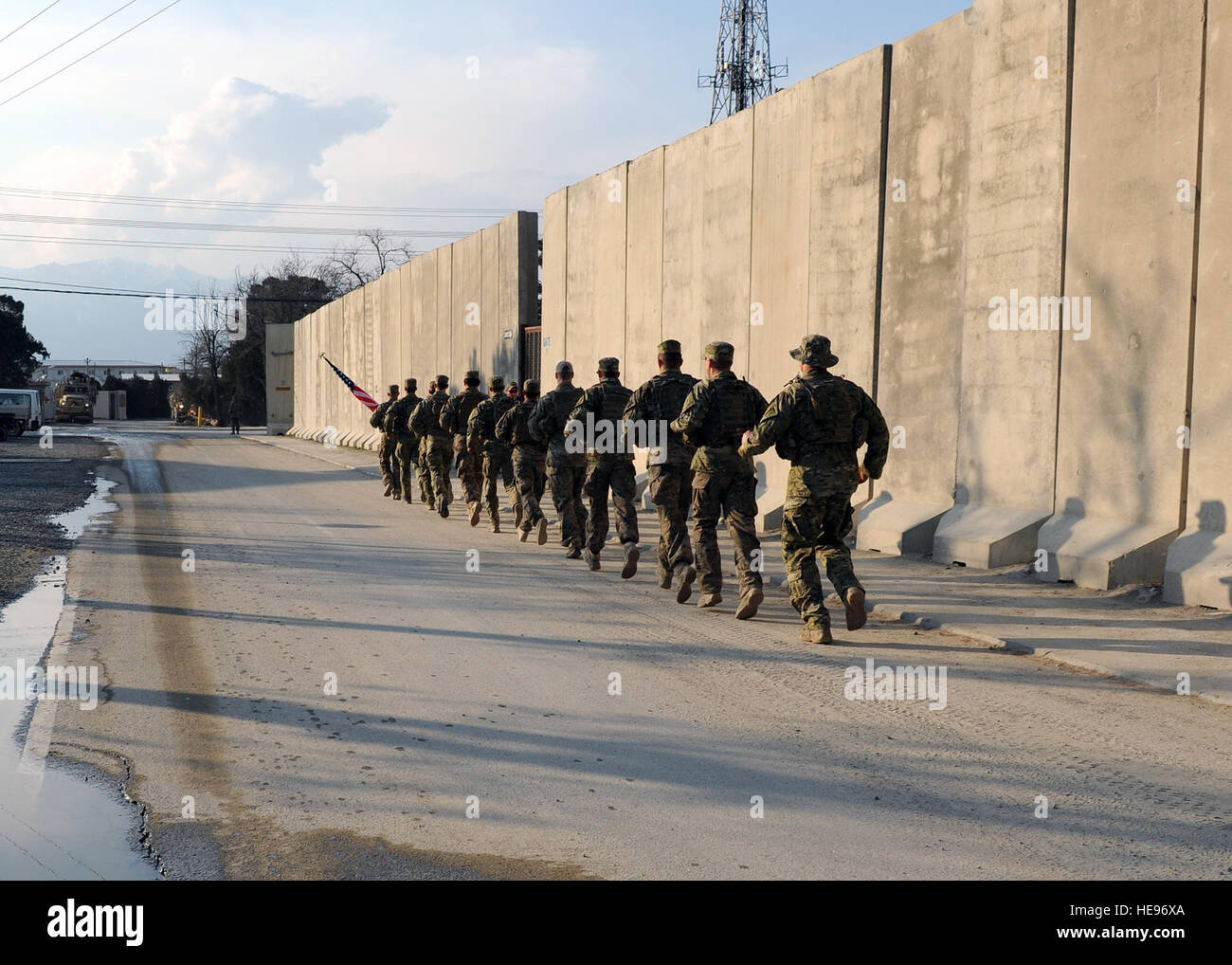 A multiservice formation of special operators runs with a U.S. flag ...