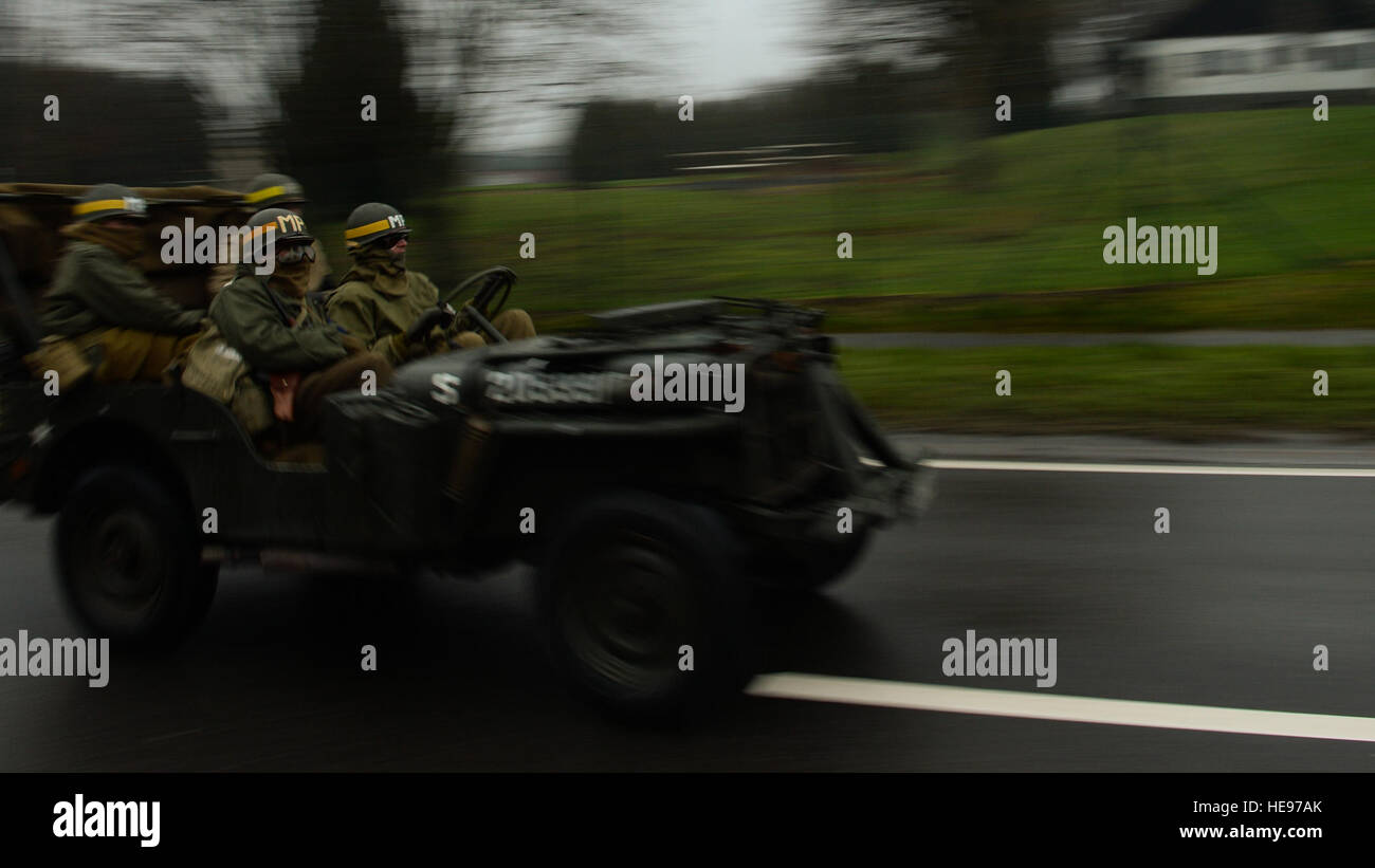 World War II-era jeeps and restored vehicles are driven by reenactors ...