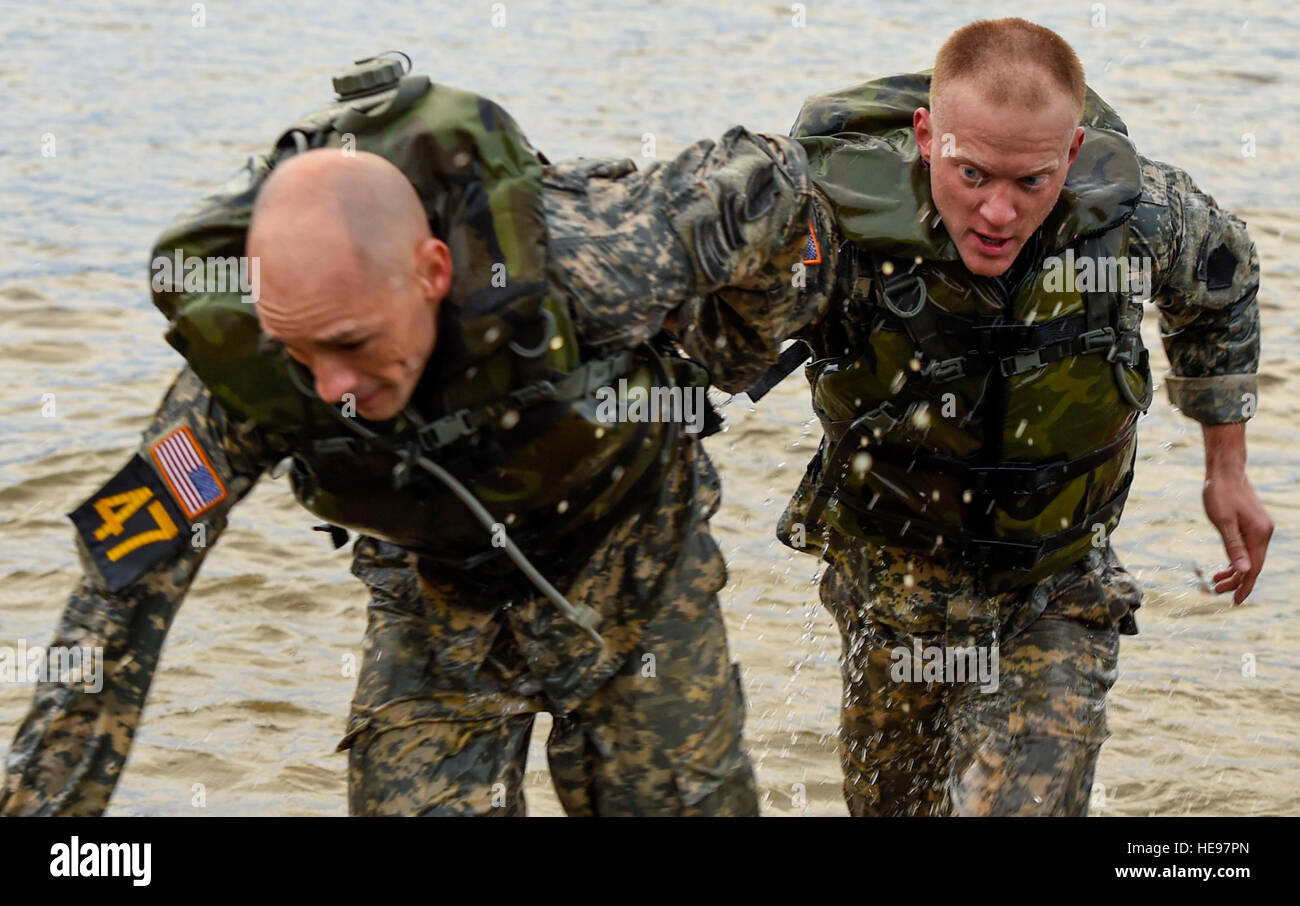 U.S. Army Capt. Robert Killian helps Staff Sgt. Erich Friedlein ...