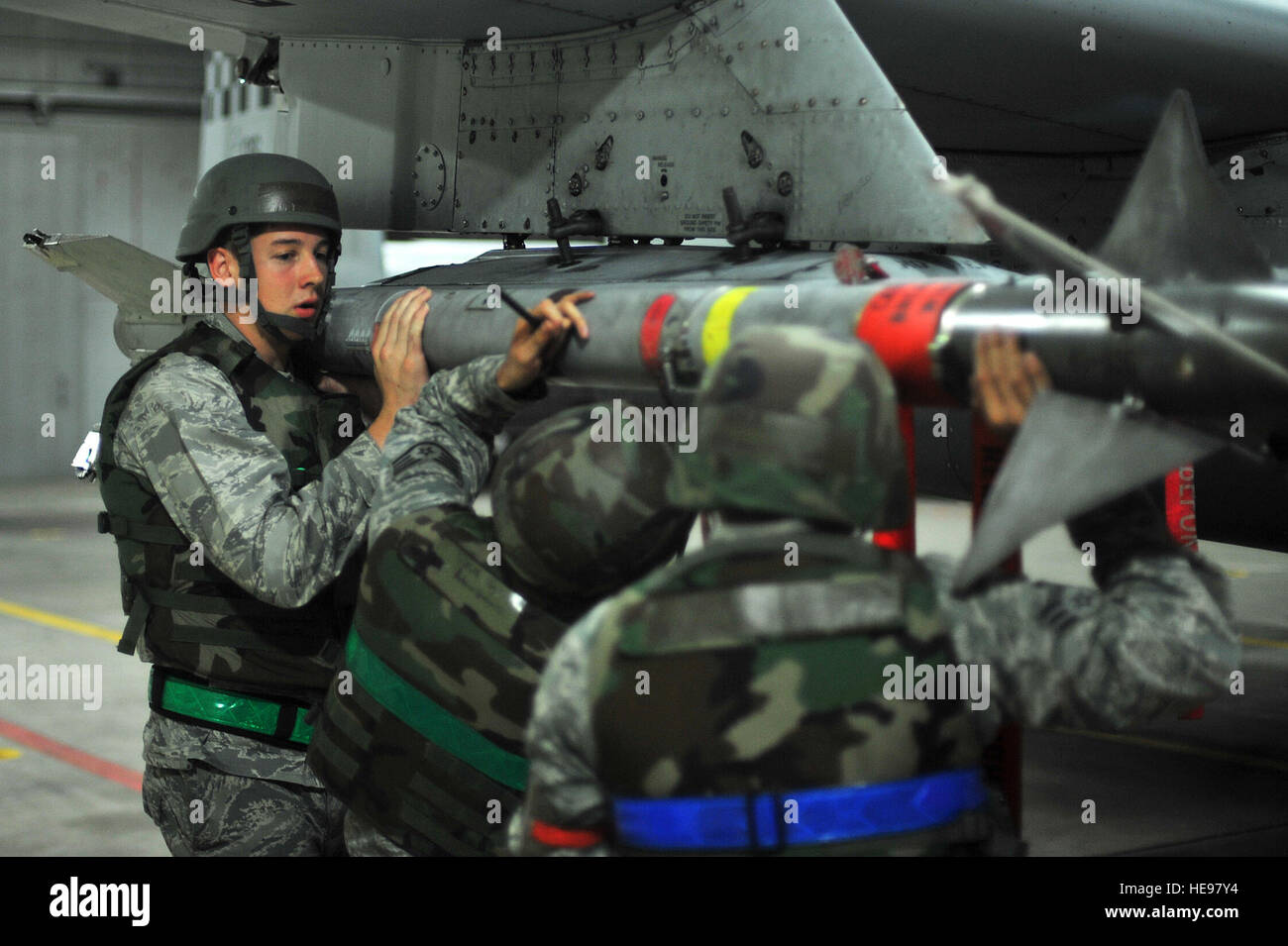 The 25th Aircraft Maintenance Unit weapons loaders load a missile on to ...