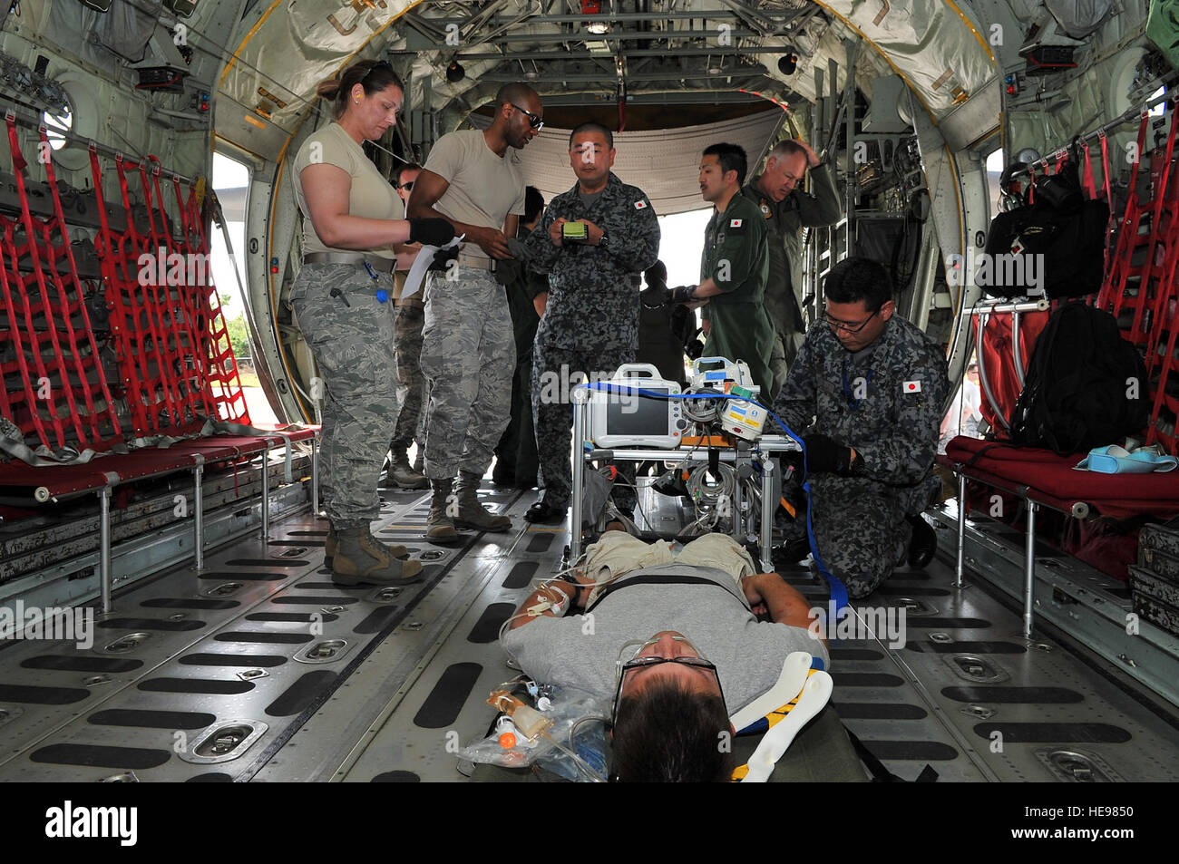 U.S. Air Force Airmen transfer a critical care patient to a Japan Air ...