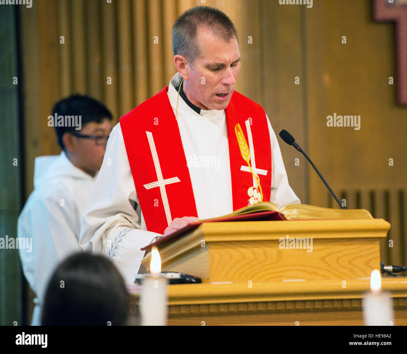 Father Jeffrey Henry reads a passage from the Gospel during the ...