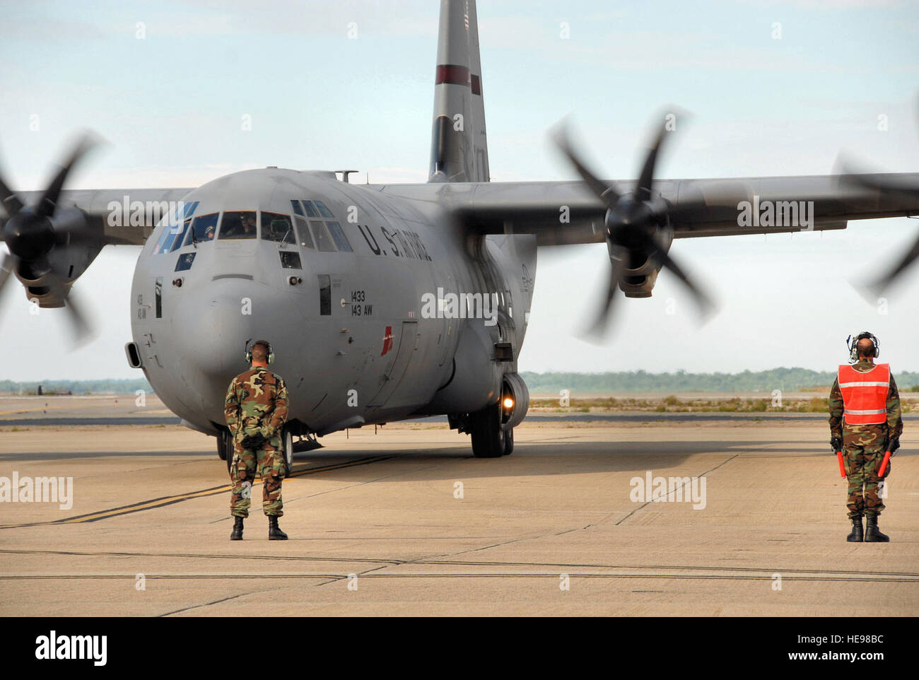Members of the 143d Maintenance Group marshall a C-130J-30 into its ...
