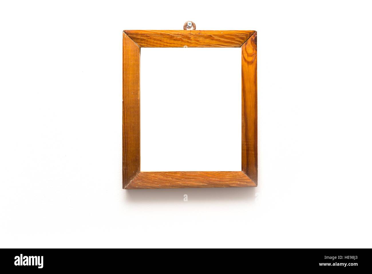Old wooden frame of pine wood hanging on white wall background. Wooden ...
