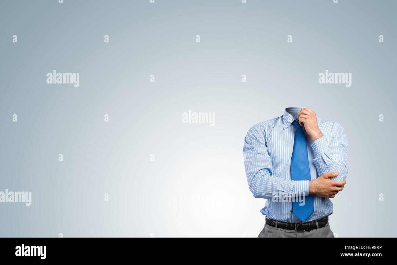 Businessman without head and his arm on chin thinking something over ...