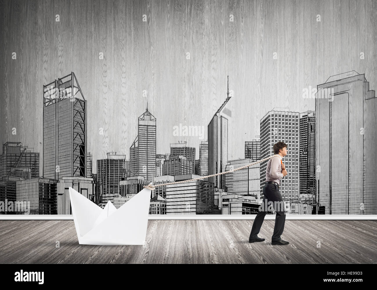 Successful businessman pulling with rope paper boat Stock Photo - Alamy