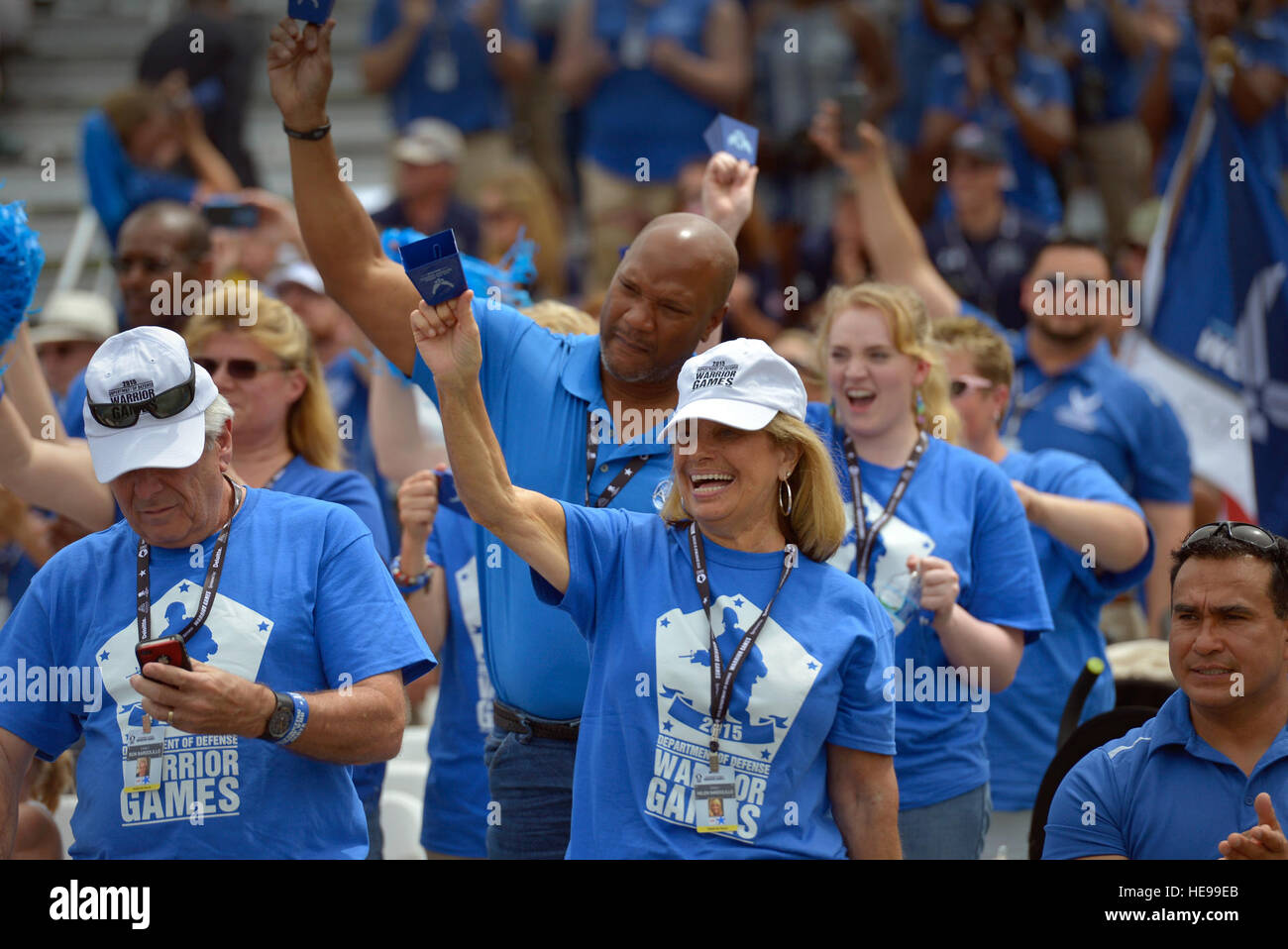 Family members cheer as members of service teams proceed on field ...