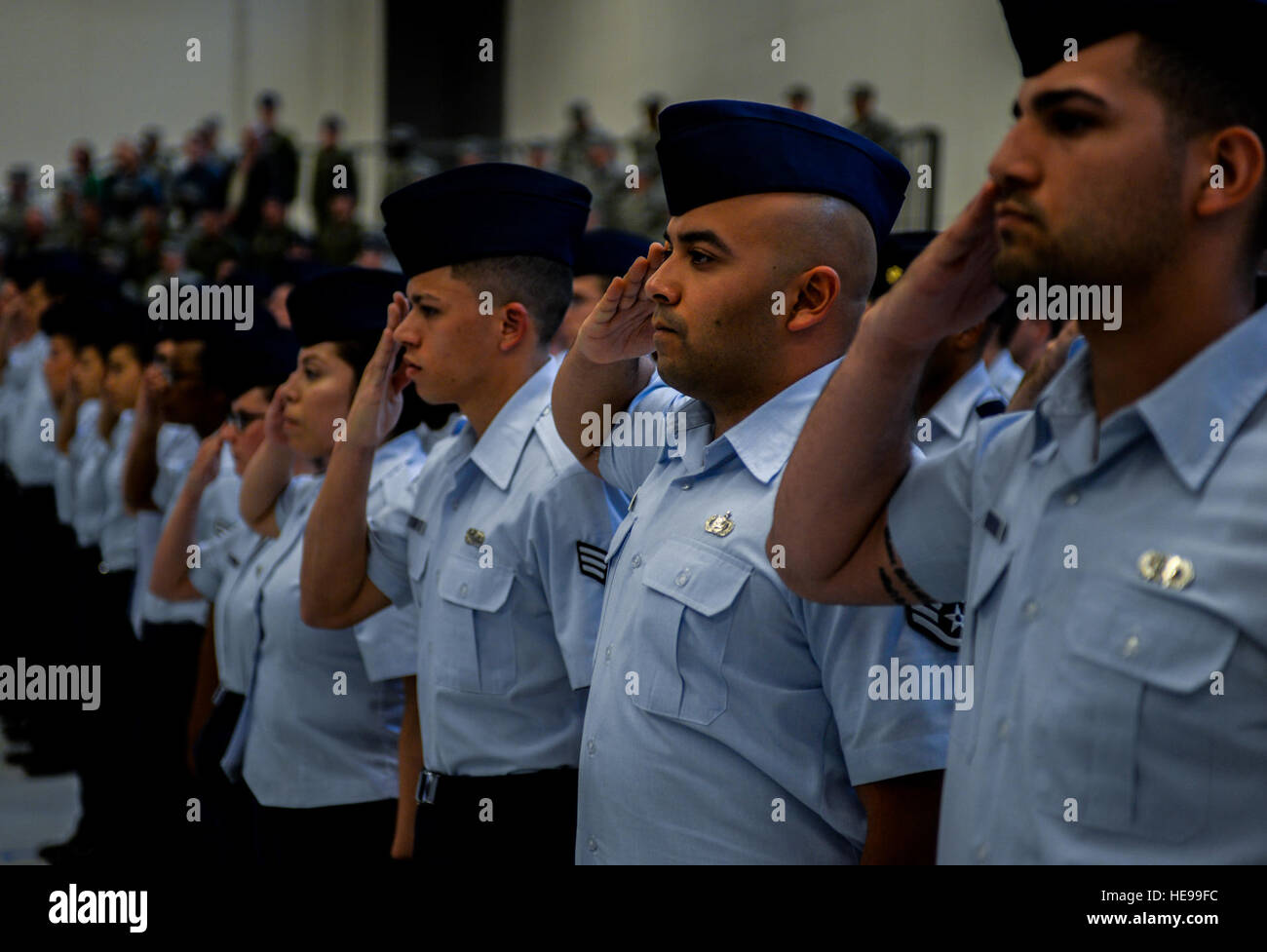 Airmen from the 57th group salute as the national anthem is played at ...