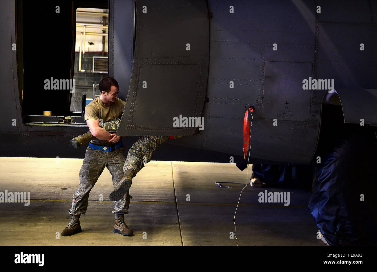 Senior Airman Trenton Strayer, assists his wingman, Senior Airman ...