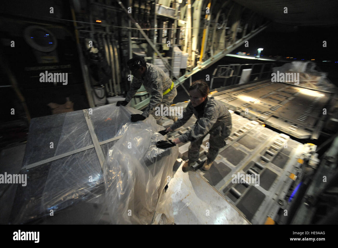 U.S. Air Force Airmen load a pallet onboard a C-130 Hercules at Baghdad ...