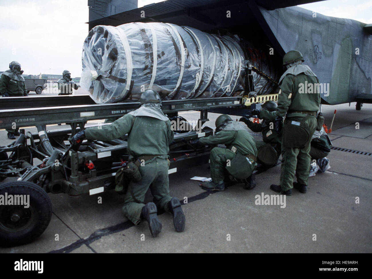 Ground crew personnel, dressed in chemical warfare protection suits ...