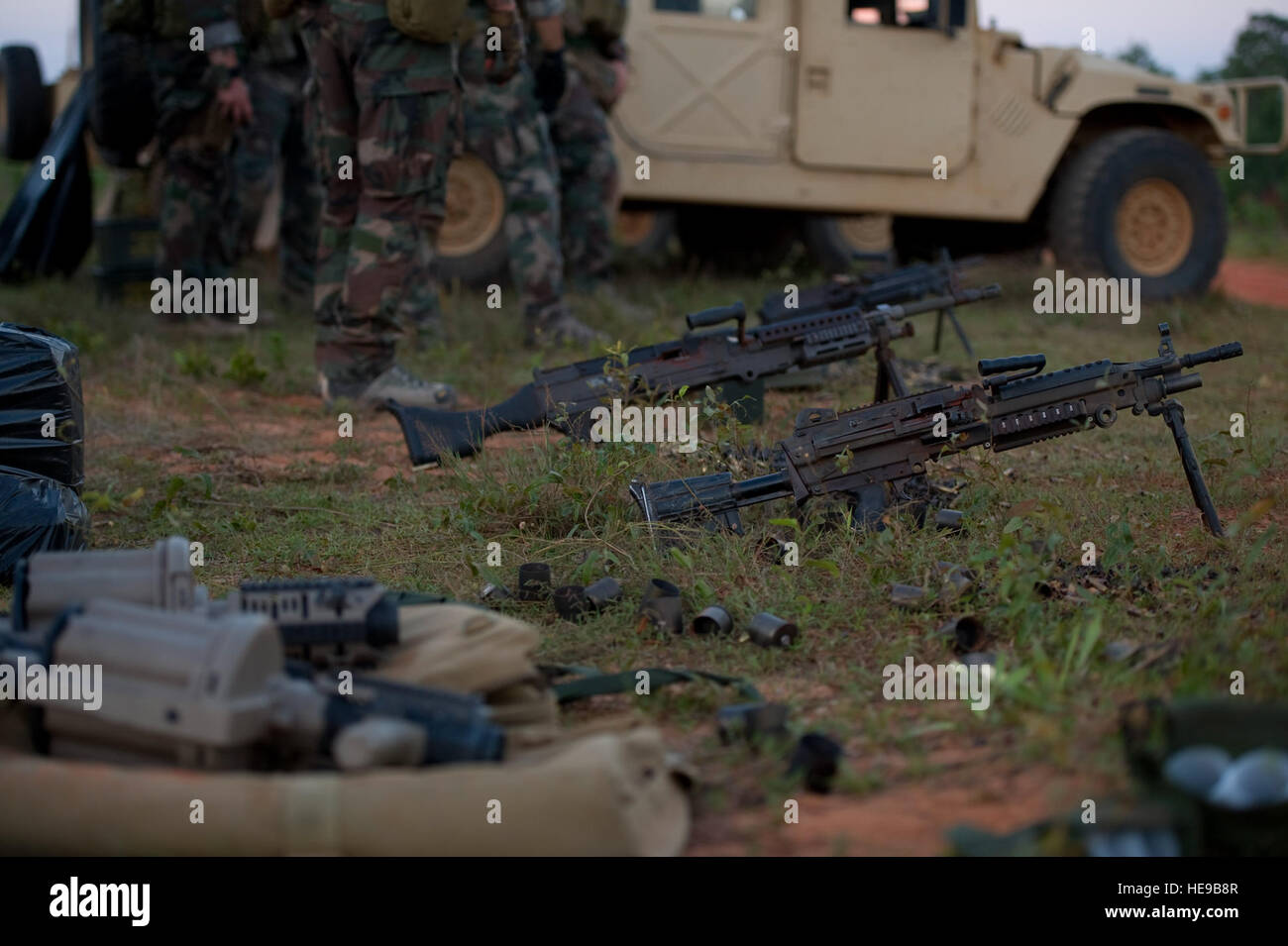 Machine guns and grenade launchers sit on the ground during a call for ...