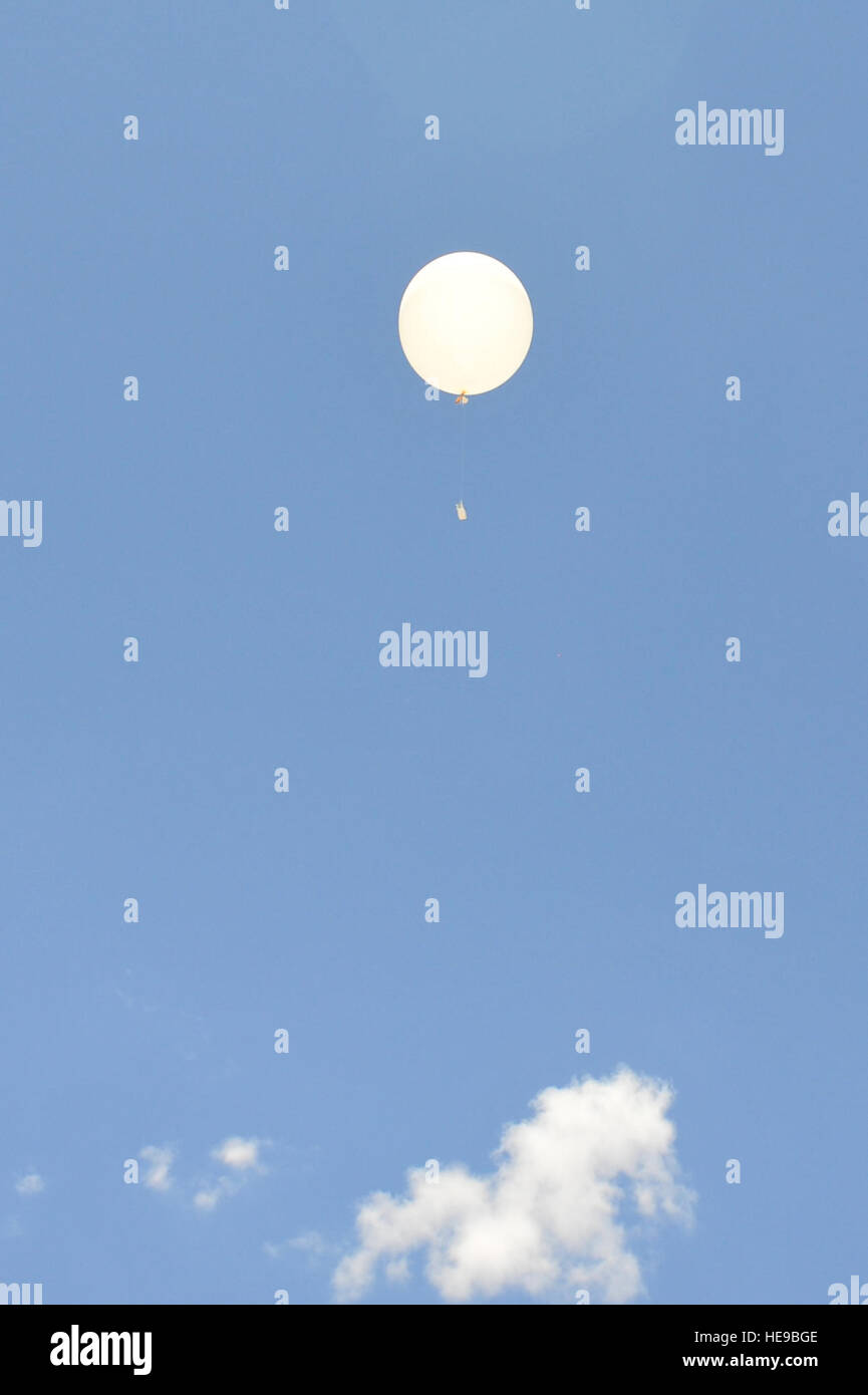 A weather balloon rises into the sky just north of the flightline at ...