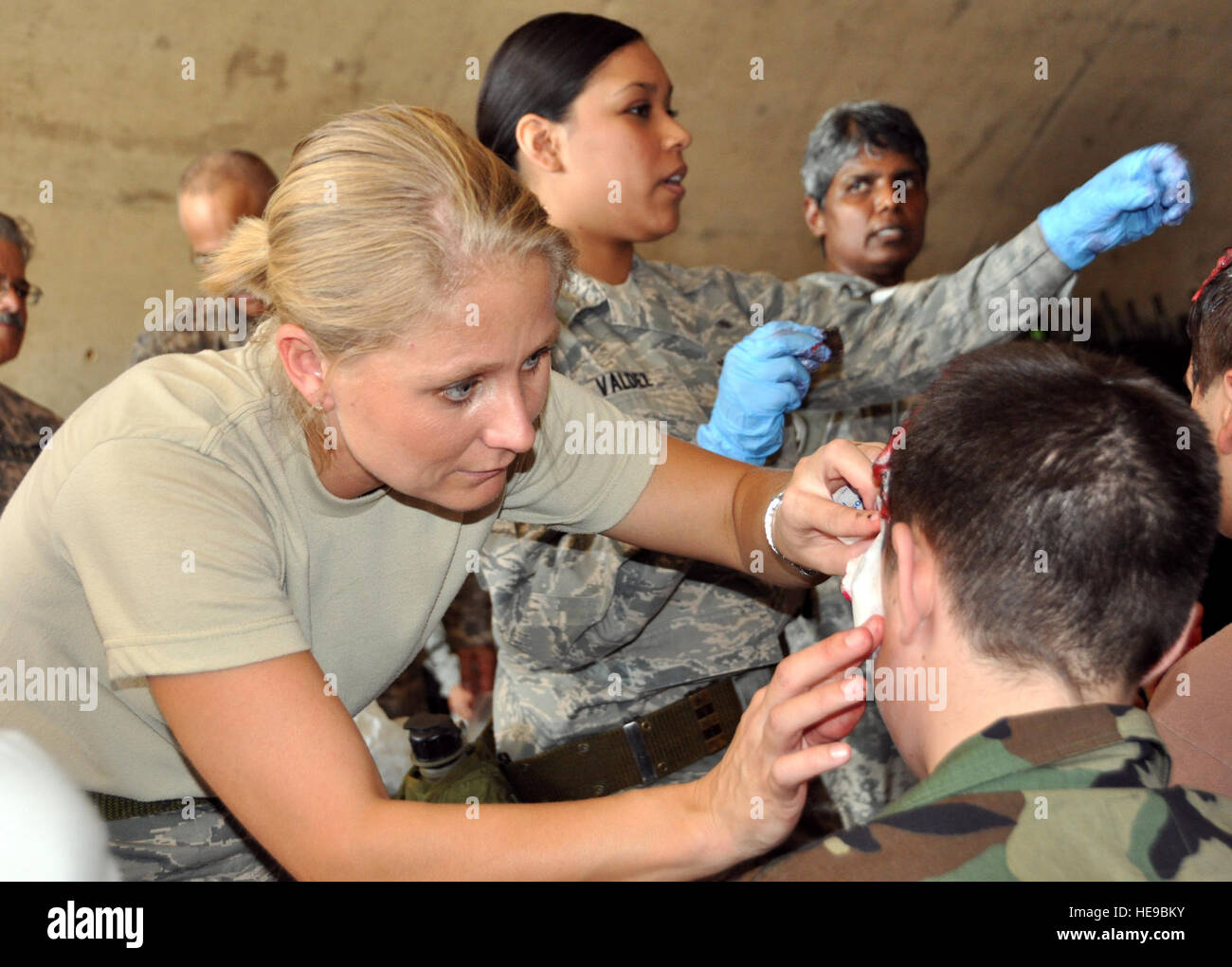 Captain Nicole Benavides 301st MDS, left, applies moulage make up to a ...