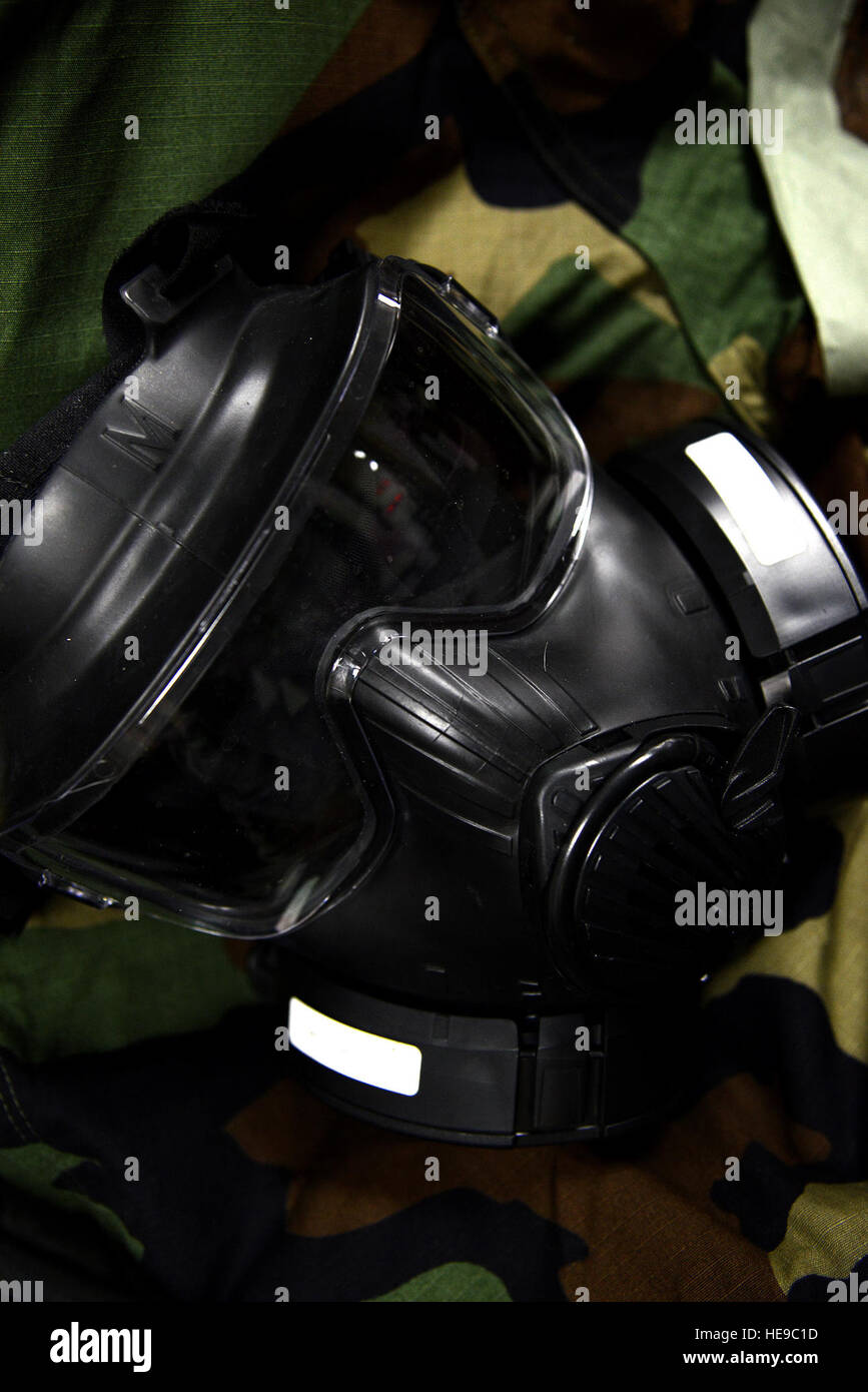 An M50 chemical protective mask rests on a ground crew ensemble at the ...