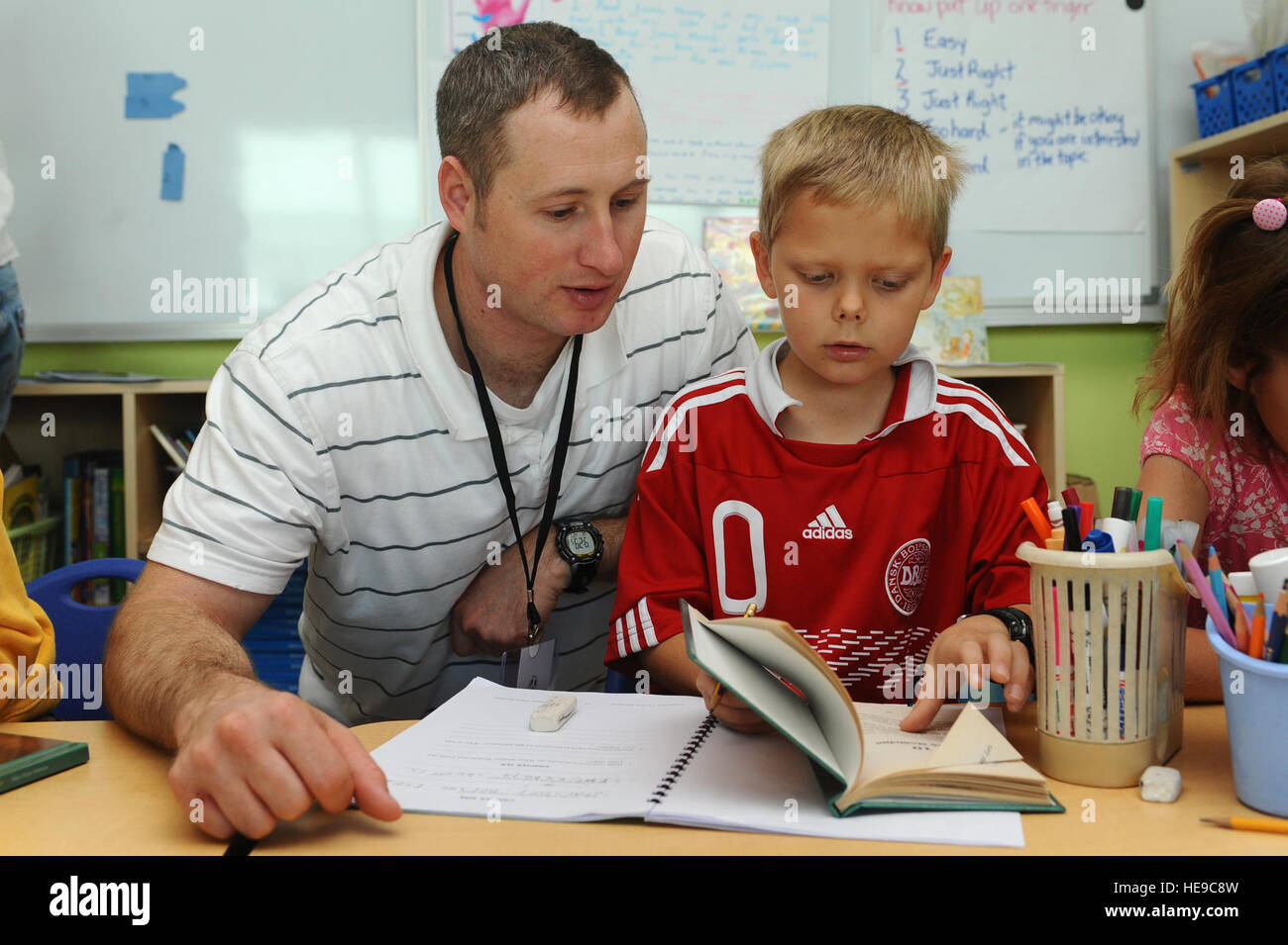 Capt. Garrell Calton, 379th Air Expeditionary Wing chaplain, assists a ...