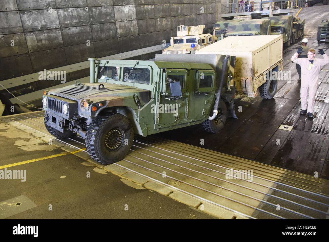 A U.S. Marine HMMWV loads onto a U.S. Navy Landing Craft Air Cushion ...