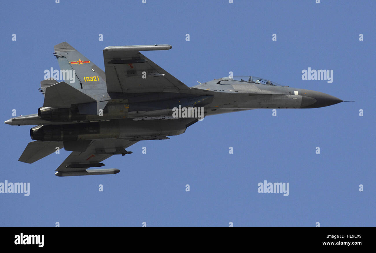 A Chinese Su-27 Flanker fighter makes a fly by while the Chairman of ...