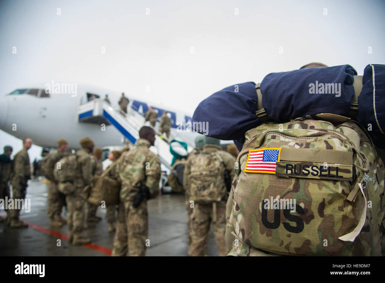 U.S. soldiers board a plane at Transit Center at Manas, Kyrgyzstan, Feb ...