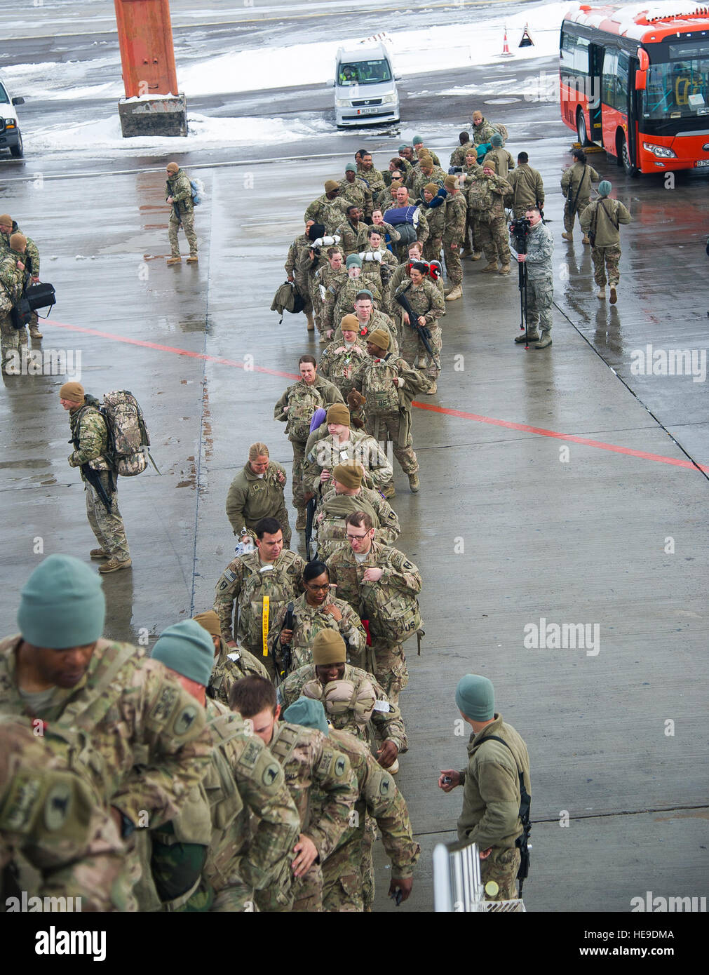 U.S. soldiers board a plane at Transit Center at Manas, Kyrgyzstan, Feb ...