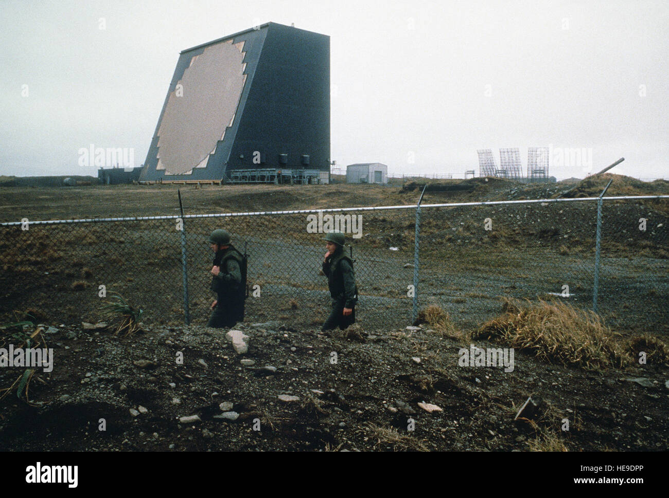 Security policemen patrol the area around the Cobra Dane radar system ...
