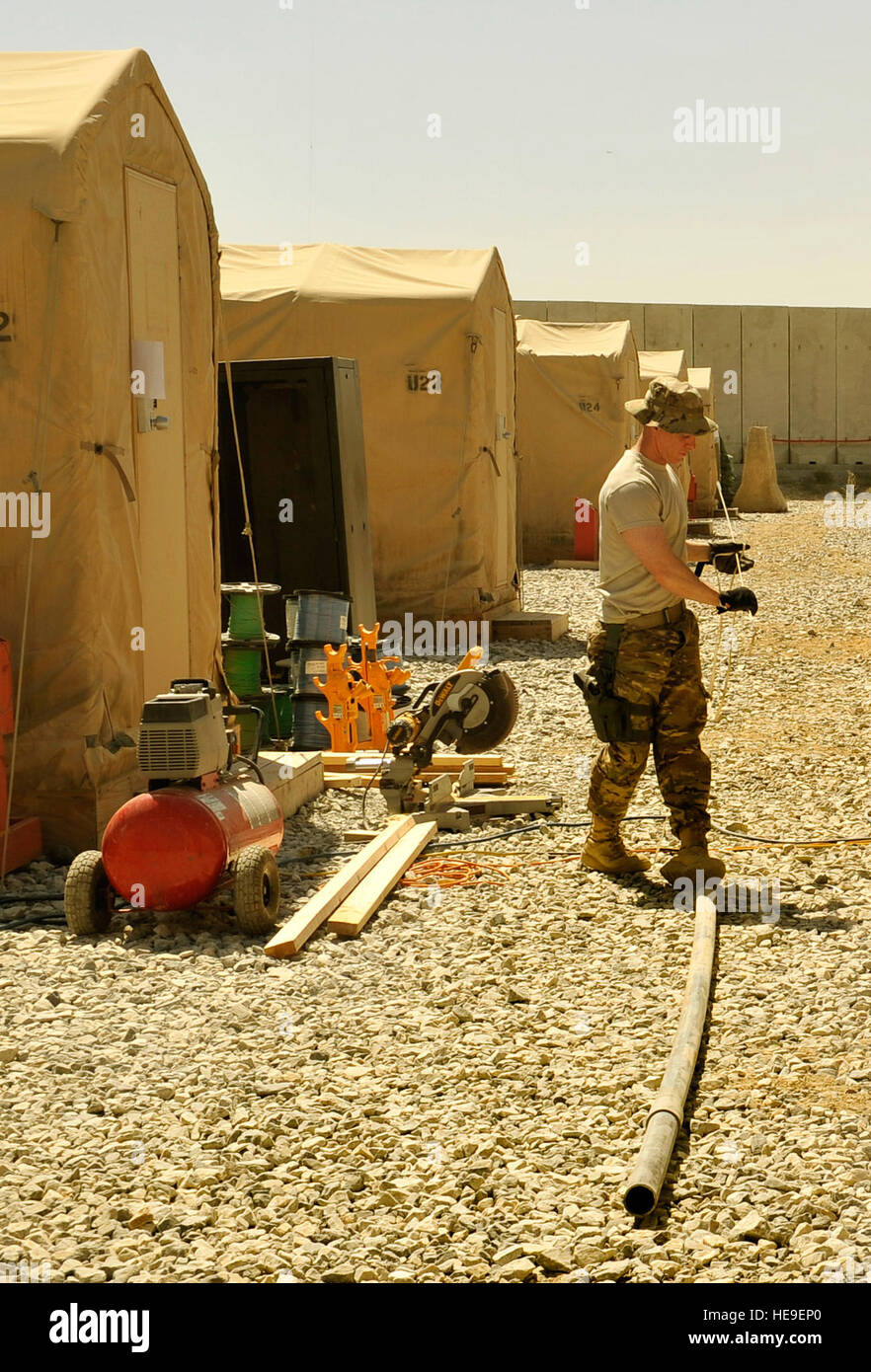 Air Force communications personnel install fiber optic cable in conduit ...