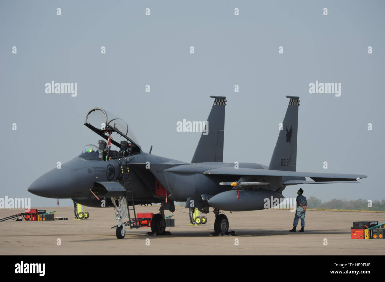 A Singapore air force crew chief monitors an F-15SG Strike Eagle ...