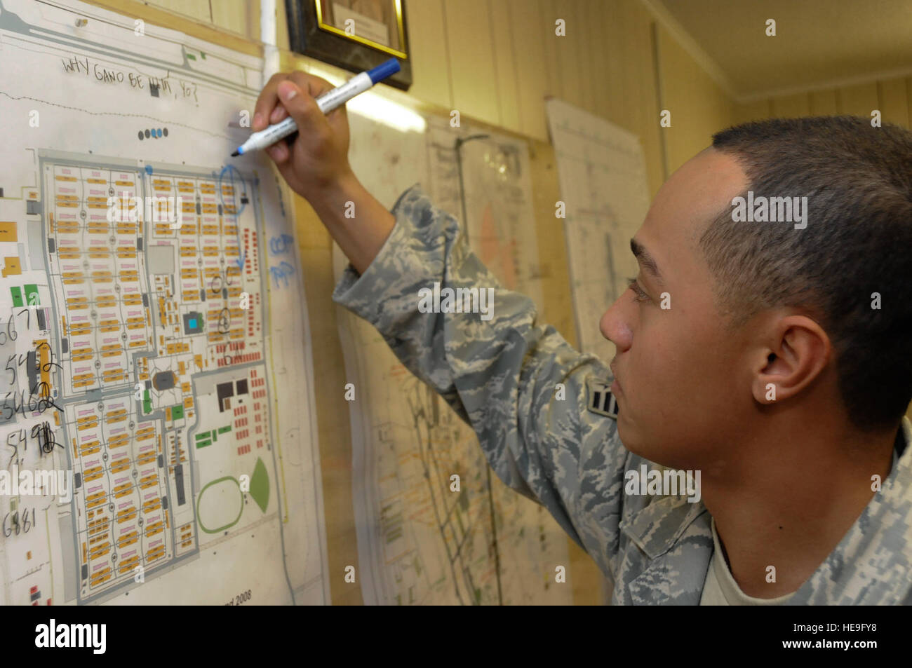 Security forces personnel manually plot a cordon on a base map for ...