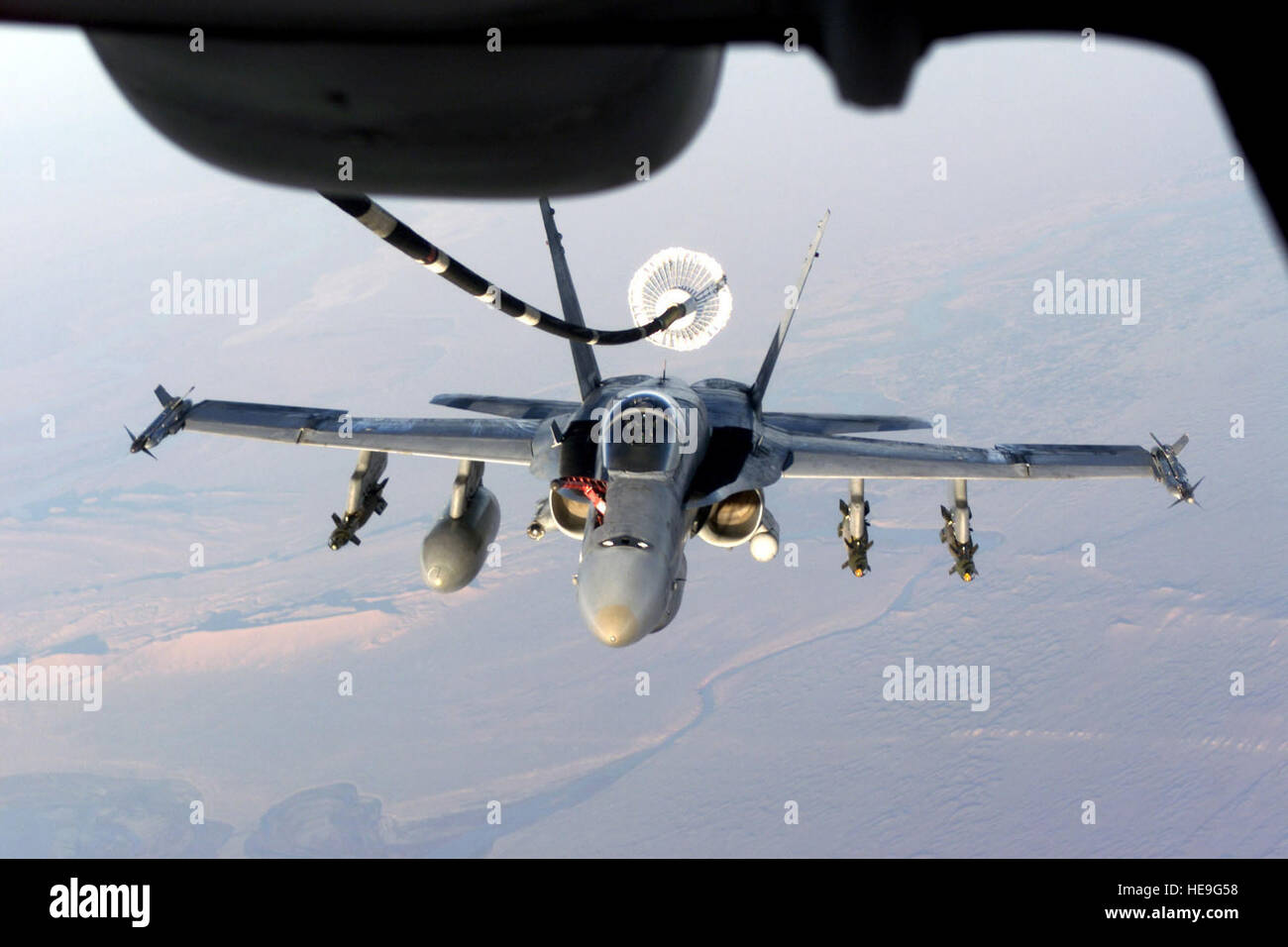 F/A-18 Hornet receives fuel from KC-10 Extender in-flight supporting ...