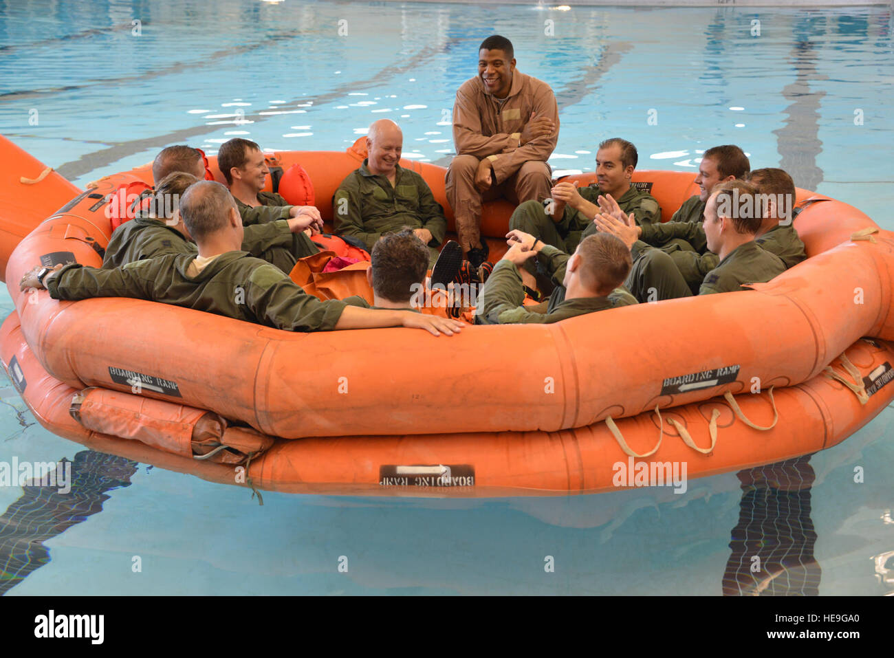 Staff Sgt. Adam Best demonstrates the proper use of a 20-person life ...