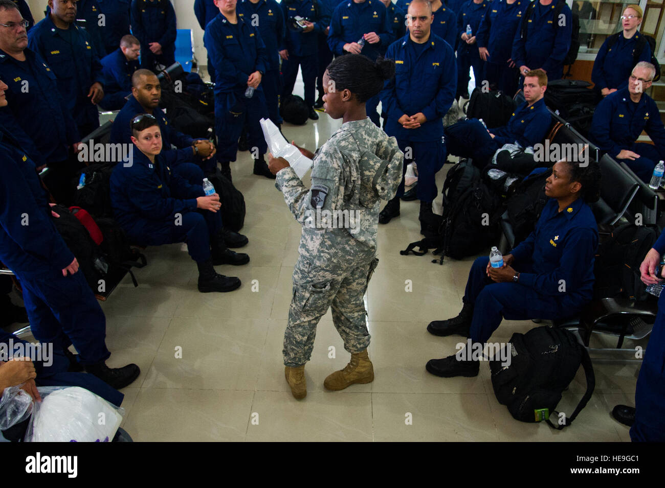 Members of the U.S. Public Health Service are briefed upon arrival by a ...