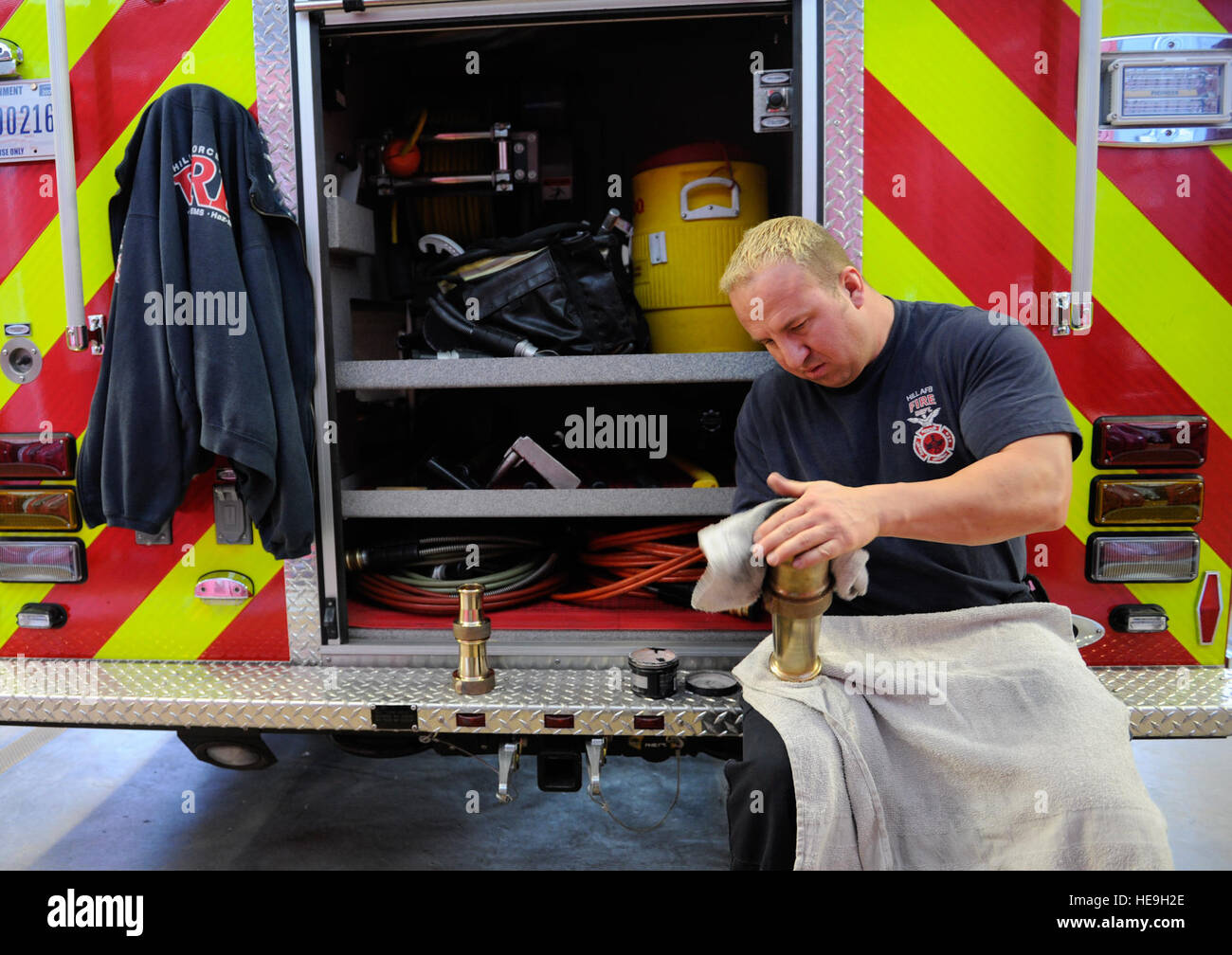 Keith Pluta, a 75th Civil Engineer Squadron firefighter, shines a brass ...