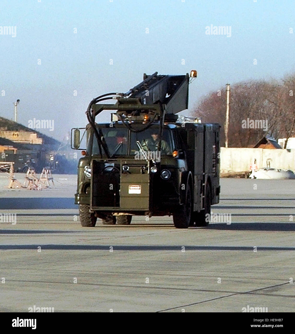 A civilian aircraft de-icing truck travels on the flight line during ...