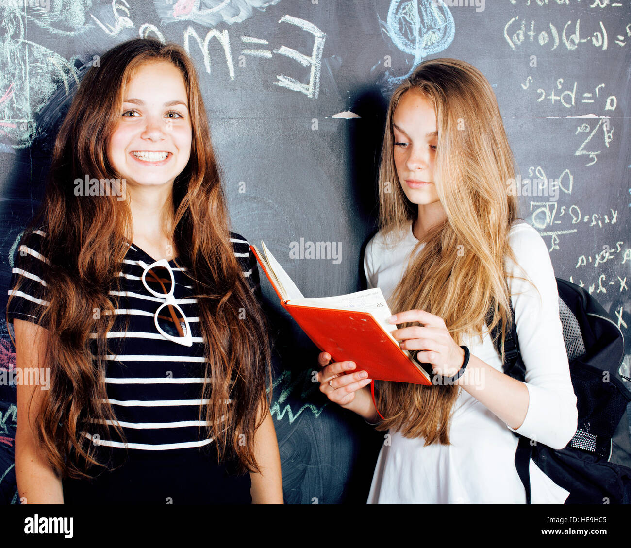 back to school after summer vacations, two teen real girls in classroom ...