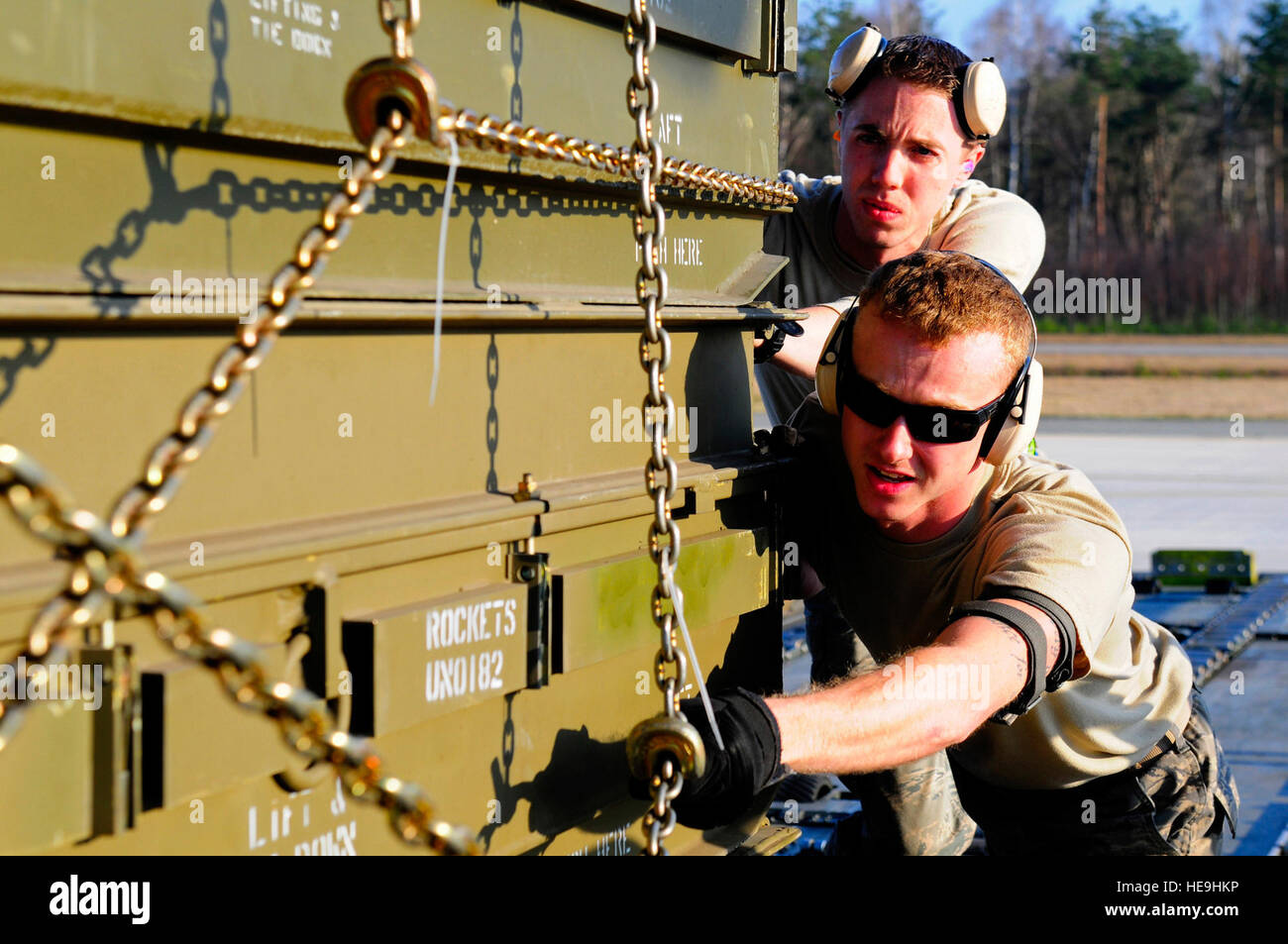 Airmen from the 721st Aerial Port Squadron load cargo onto a C-130J ...