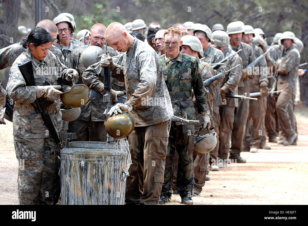 U.S. Air Force Academy basic cadets dunk their training rifles and ...