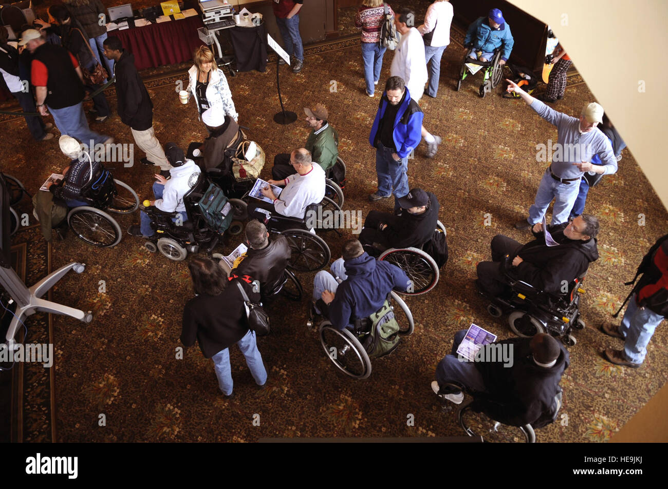 Participants line up inside The Silver Tree Hotel Mar. 29 to register ...