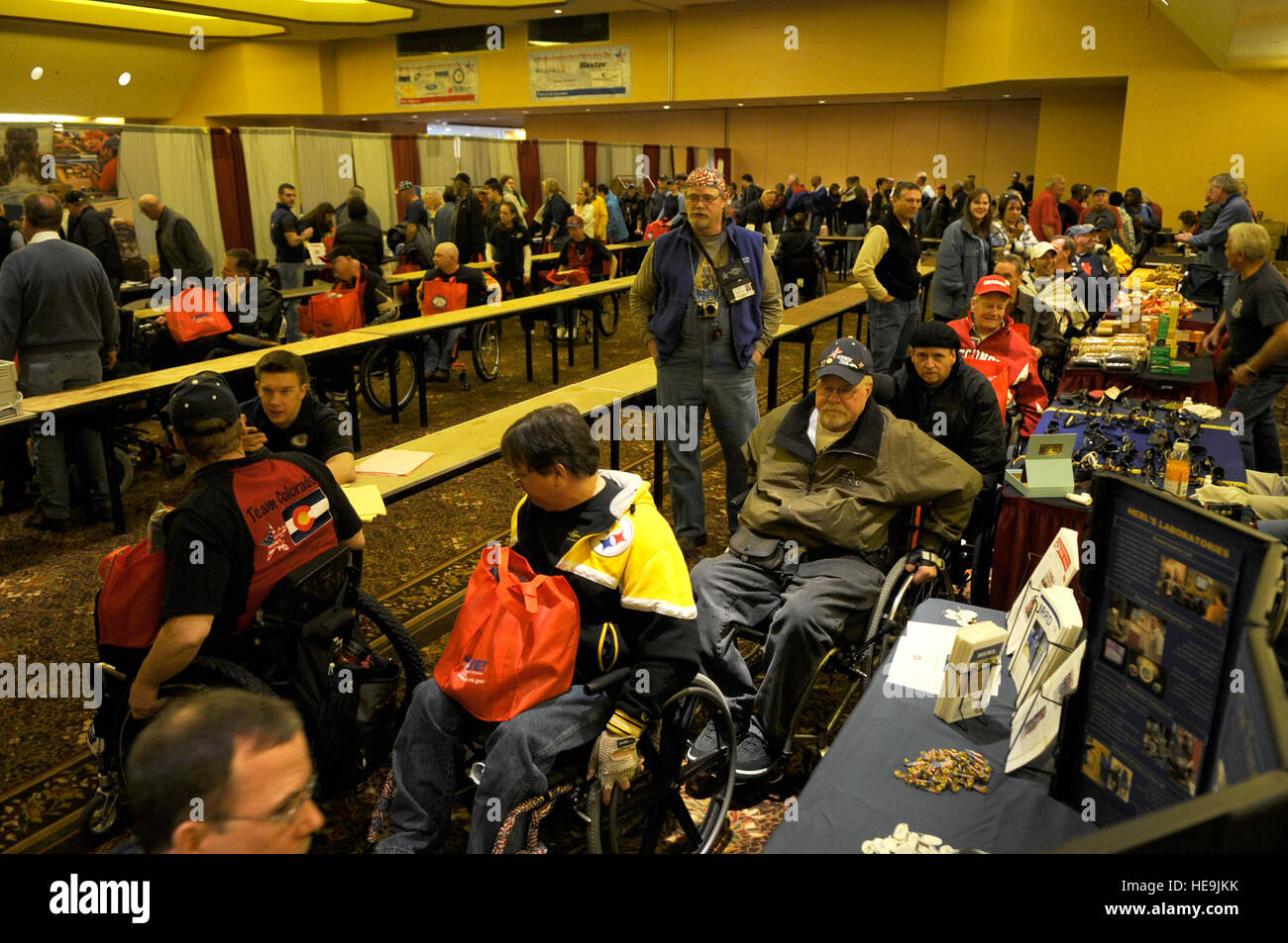 Participants line up inside The Silver Tree Hotel Mar. 29 to register ...