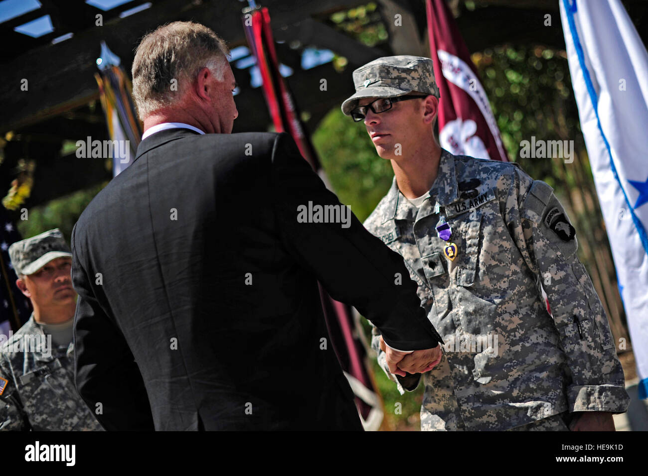 Deputy Secretary of Defense William J. Lynn III congratulates Spc ...