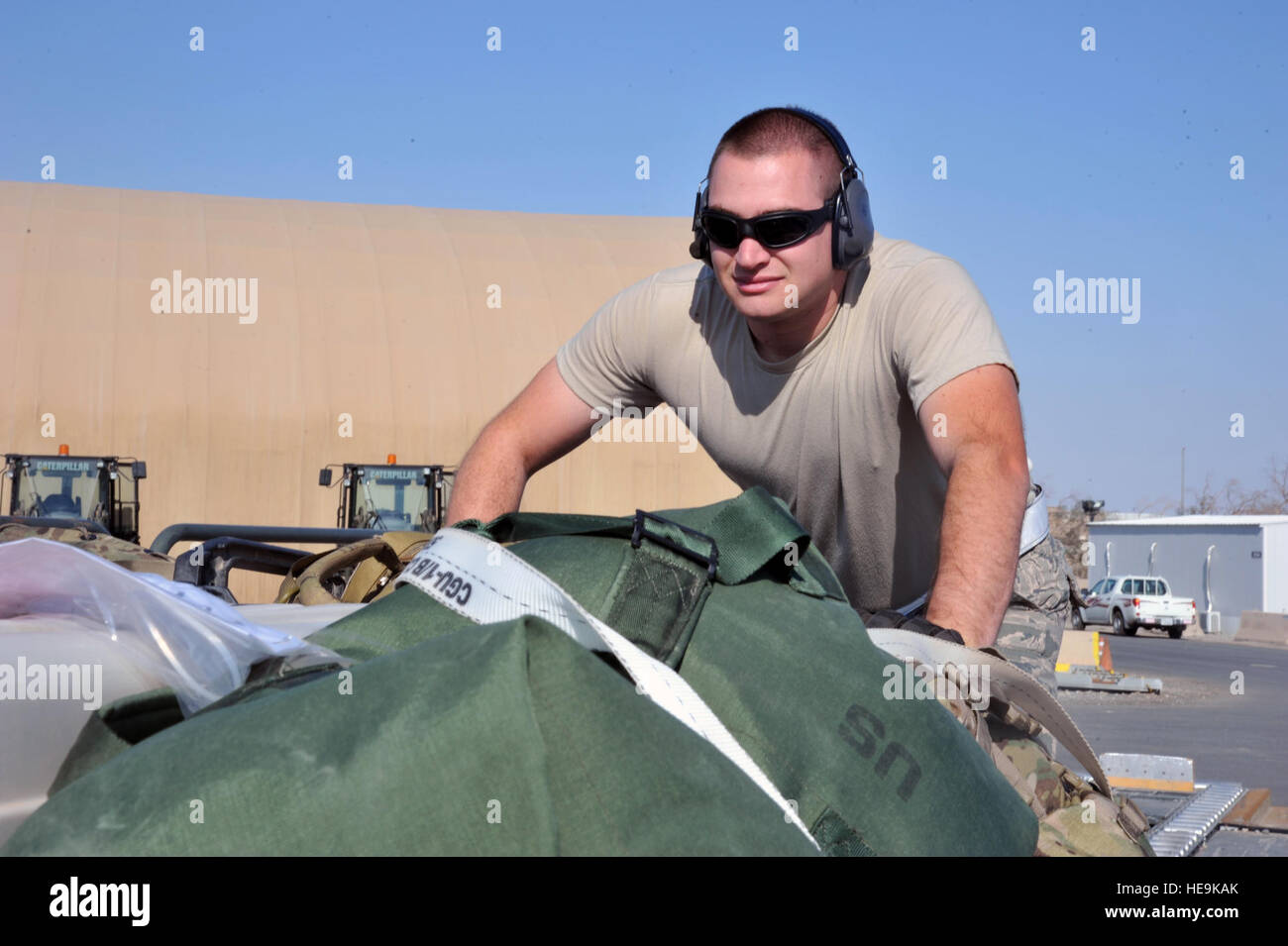 U.S. Air Force Airman 1st Class Levi Page pushes cargo onto the 60K ...