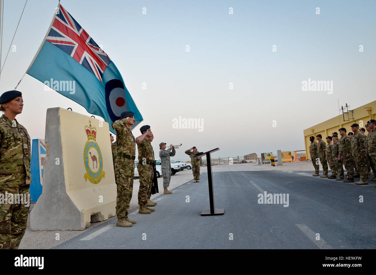 Royal Air Force service members respectfully stand at attention as Capt ...