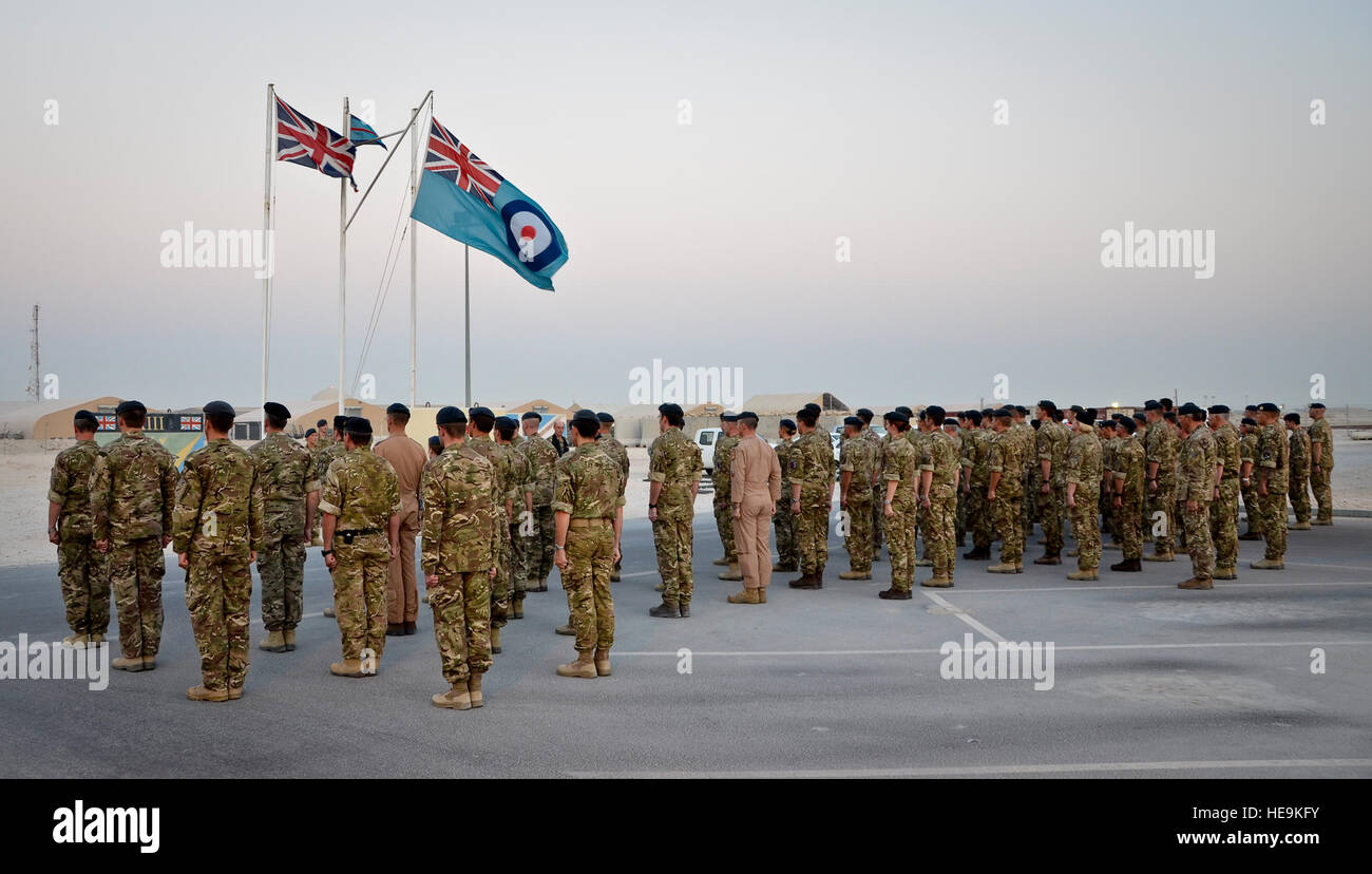 Royal Air Force service members respectfully stand at attention as Capt ...