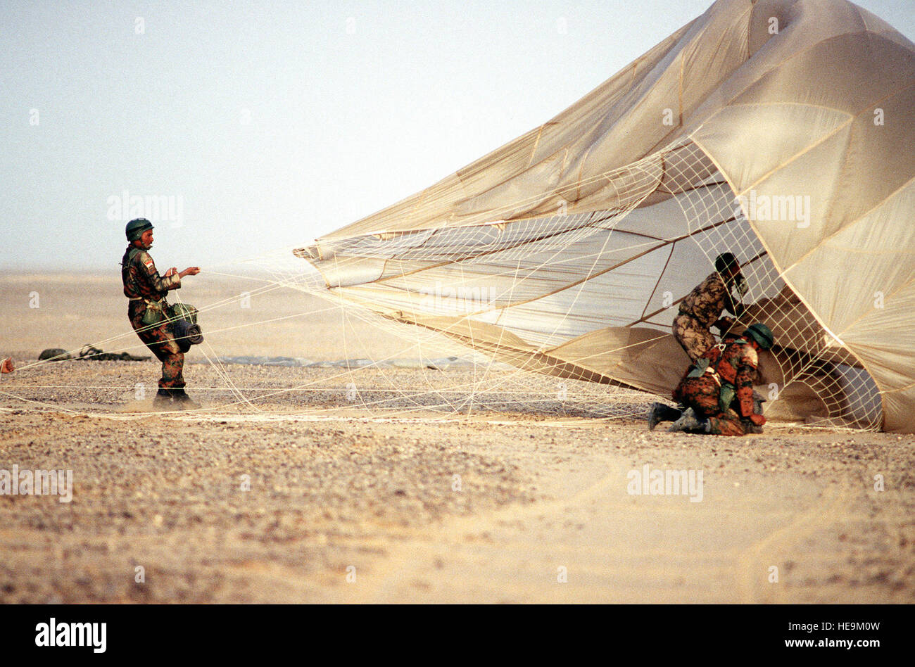 Egyptian troops gather a parachute after a mass halo jump. The main ...
