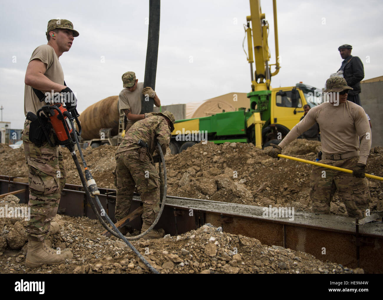 Members of the 455th Expeditionary Civil Engineer Squadron pour ...