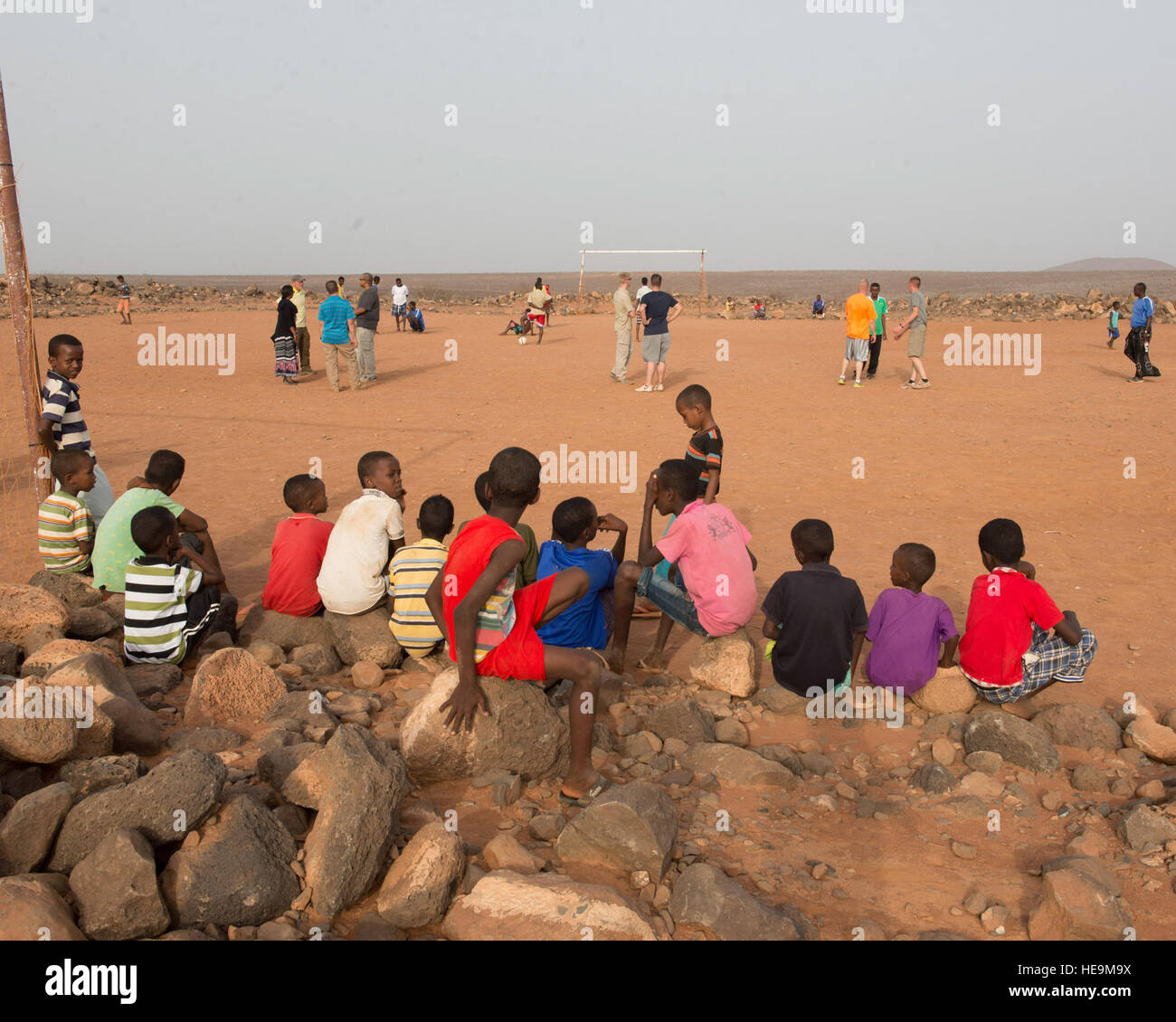 Children watch service members from the 407th Civil Affairs Battalion ...