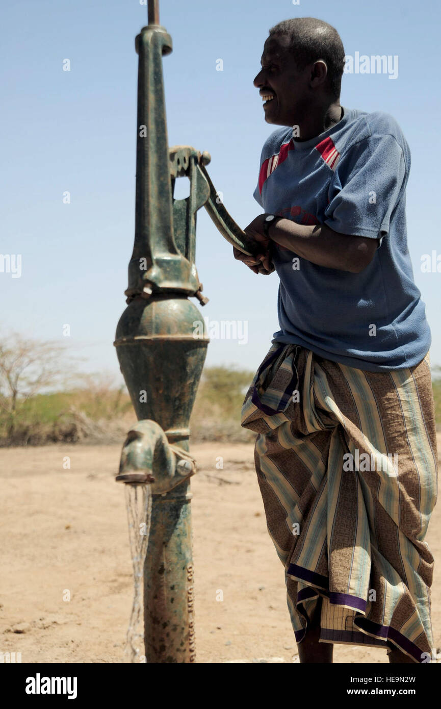 Ahamed Kiffeh, from the village of Bonta pumps water from a well ...